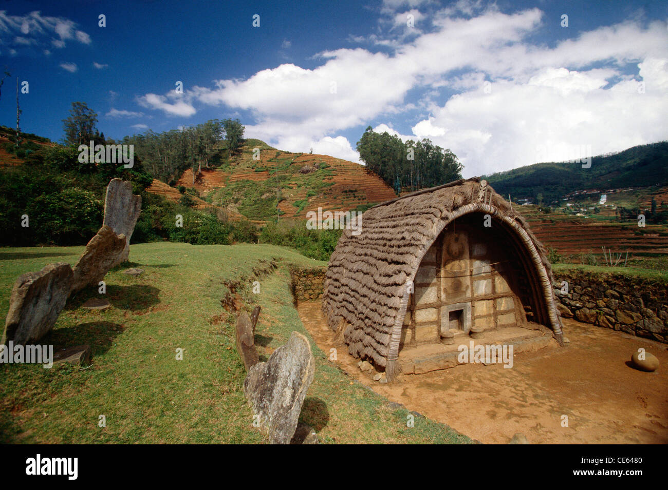 Toda tribe tiny thatched roofed Hindu temple with carved wooden door ...