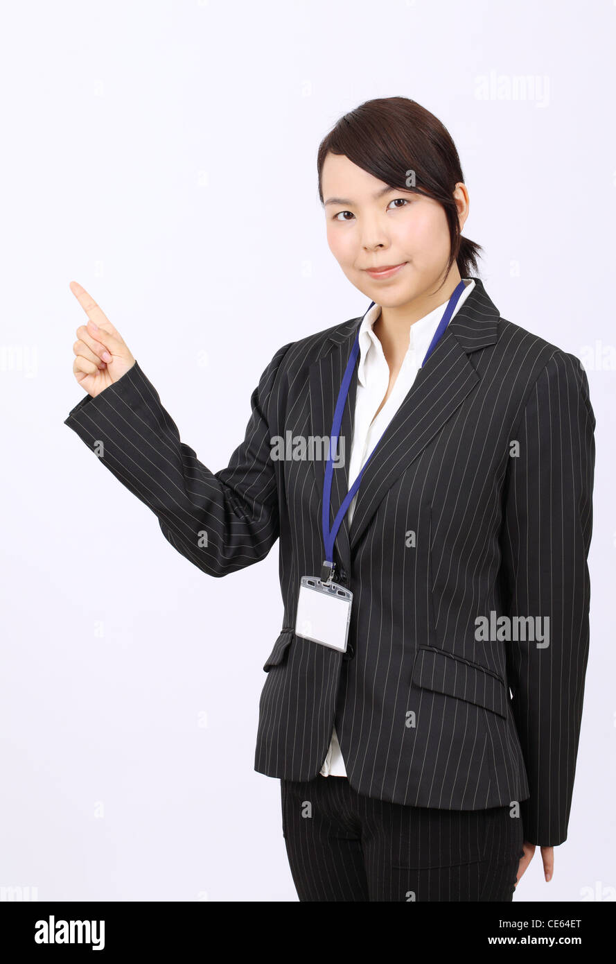 Smiling asian business woman rise hand and pointing copy space Stock ...