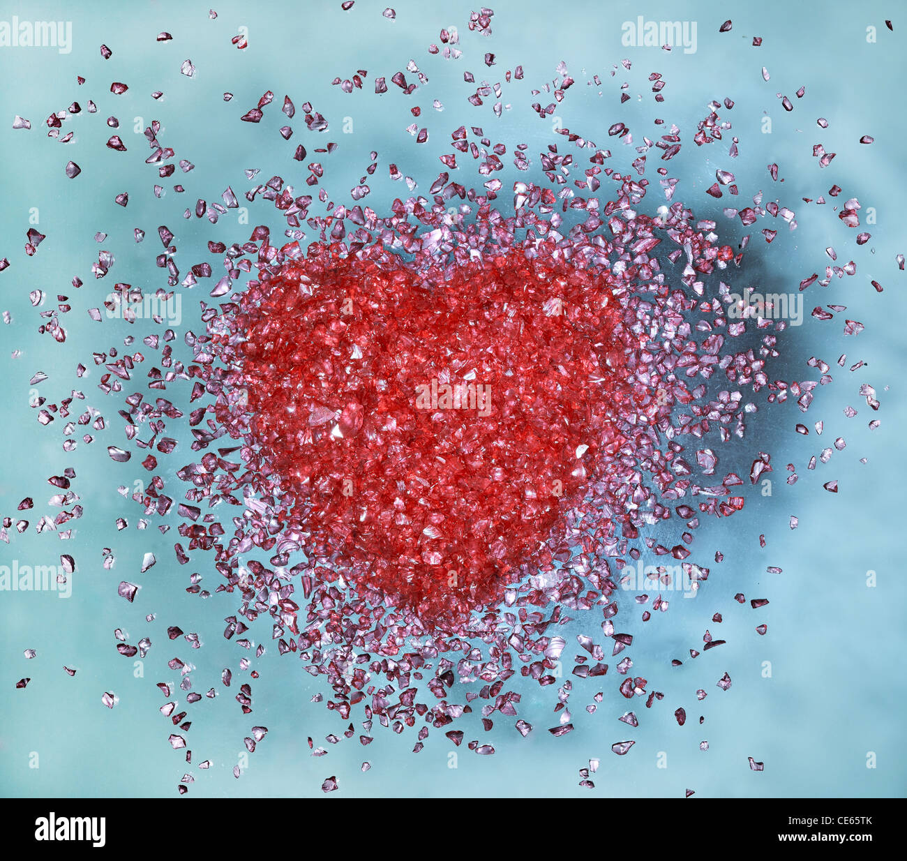 Ruby red heart on a cold blue background Stock Photo - Alamy