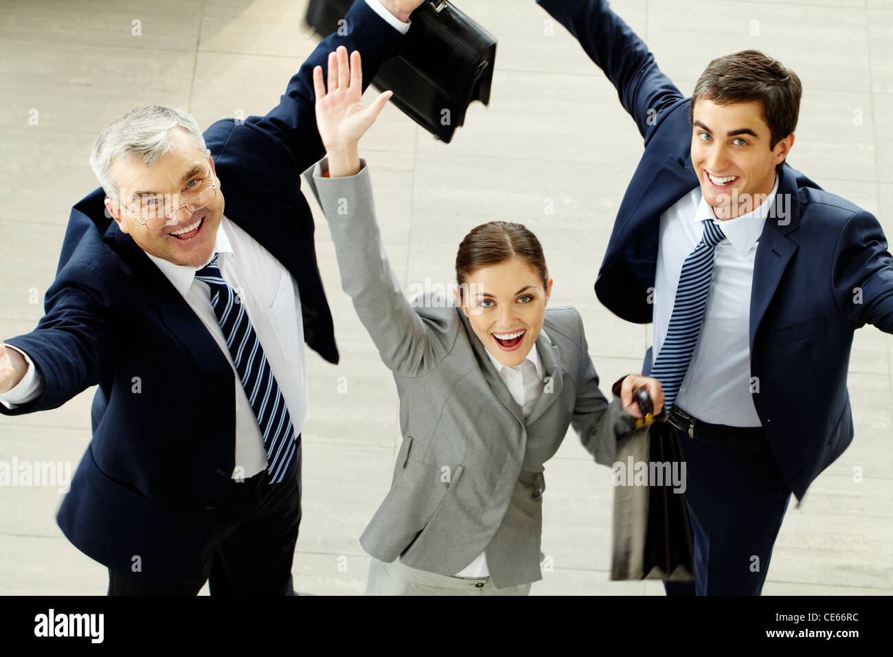 Above angle of joyful business group looking at camera Stock Photo - Alamy