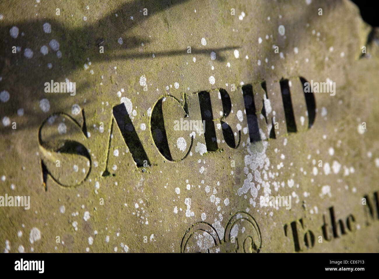 The word "Sacred" on a gravestone Stock Photo - Alamy