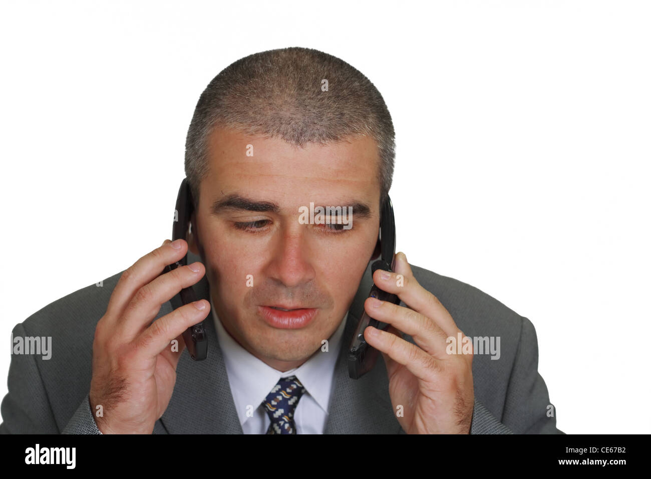 A funny busy businessman using two mobile phones Stock Photo - Alamy