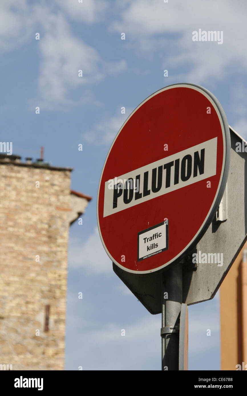 pollution sticker placed on no entry road traffic sign in city town ...