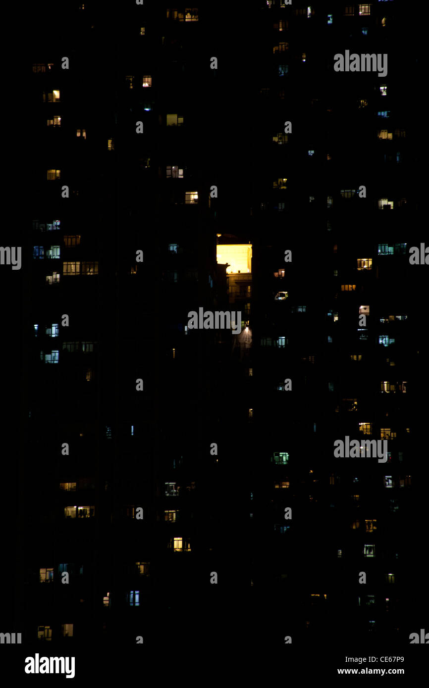 Lights of tower blocks and city lights at night reflected in the Shing ...