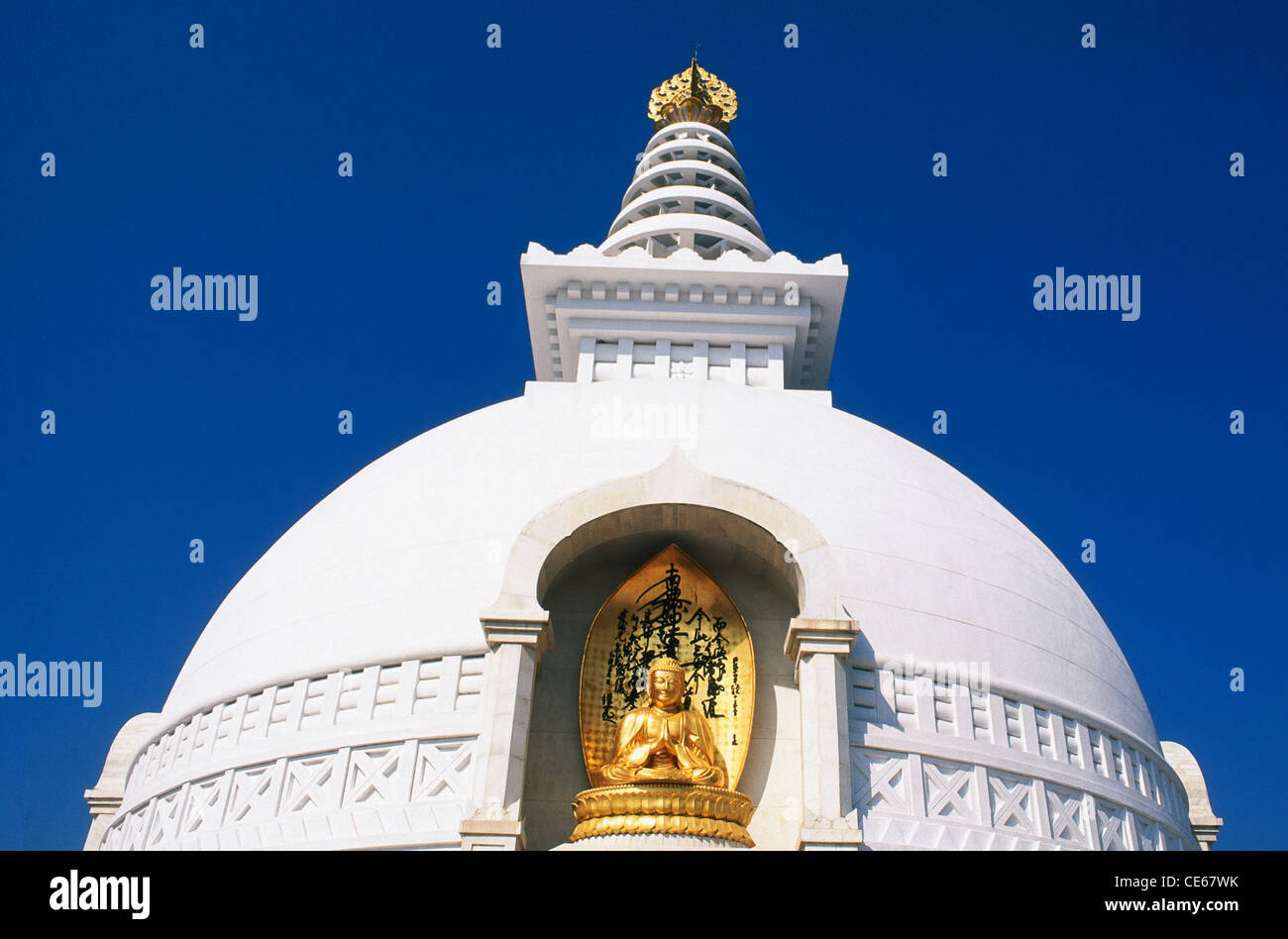 Golden idol of Buddha on Vishwa Shanti stupa ; Rajgir ; Bihar ; India ...
