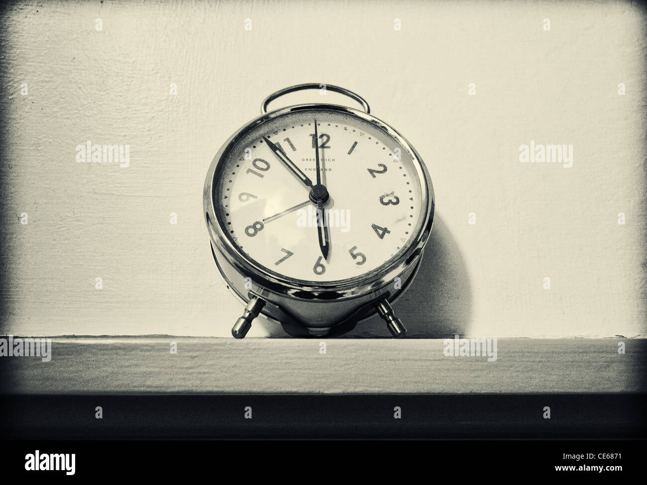 old style alarm clock on a shelf Stock Photo - Alamy