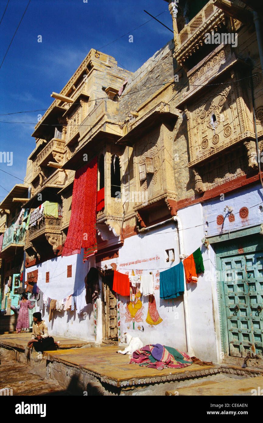Indian laundry drying in front of houses ; street scene of small town ...