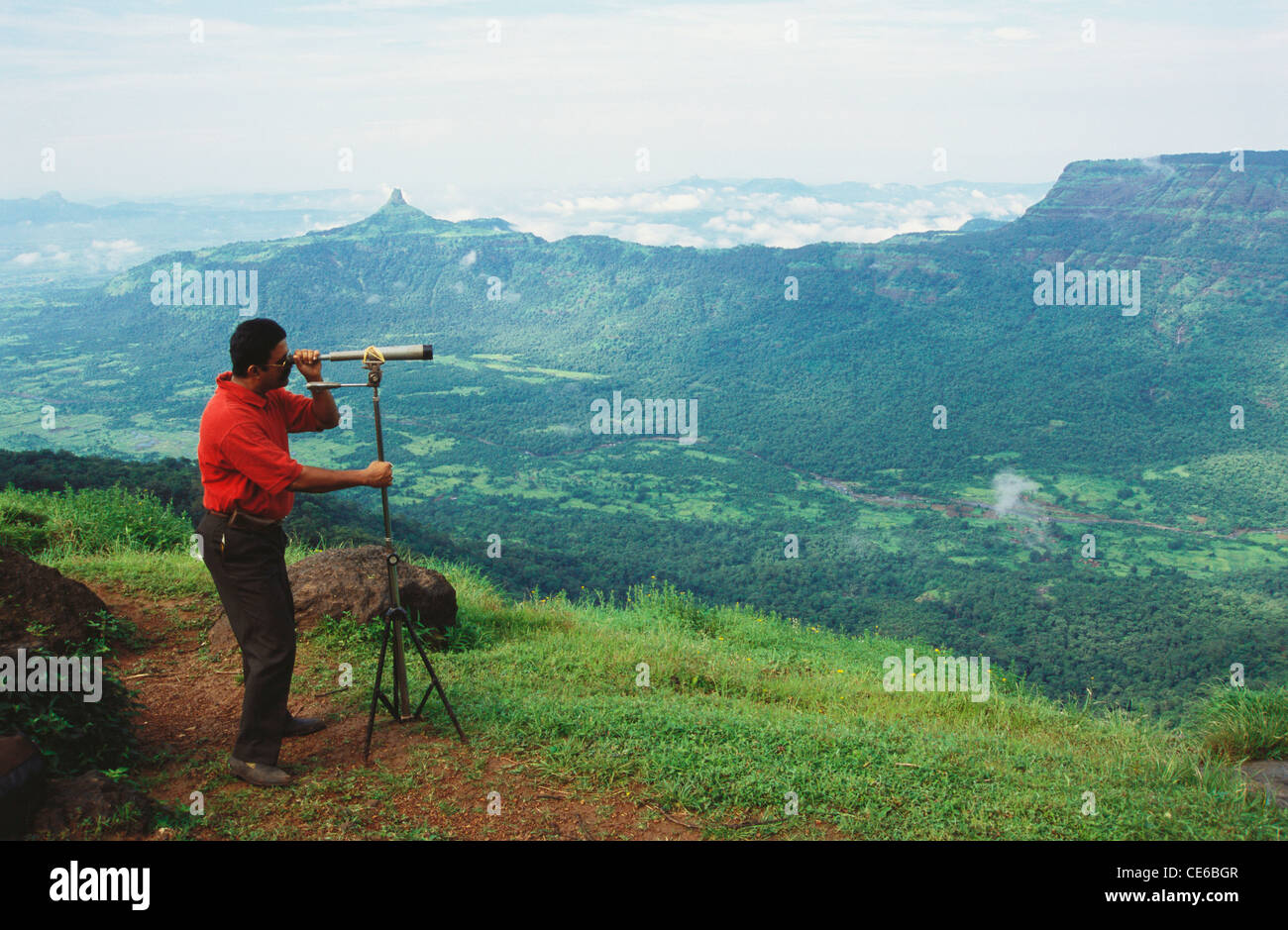 Man using telescope ; Belvedere Point ; Matheran ; Maharashtra ; India ...