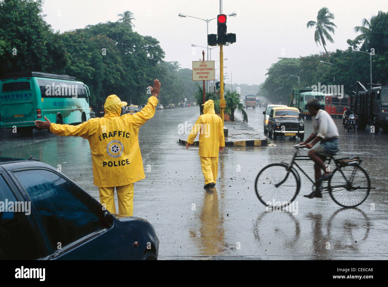 Traffic policeman controlling traffic car bus bicycle at intersection ...