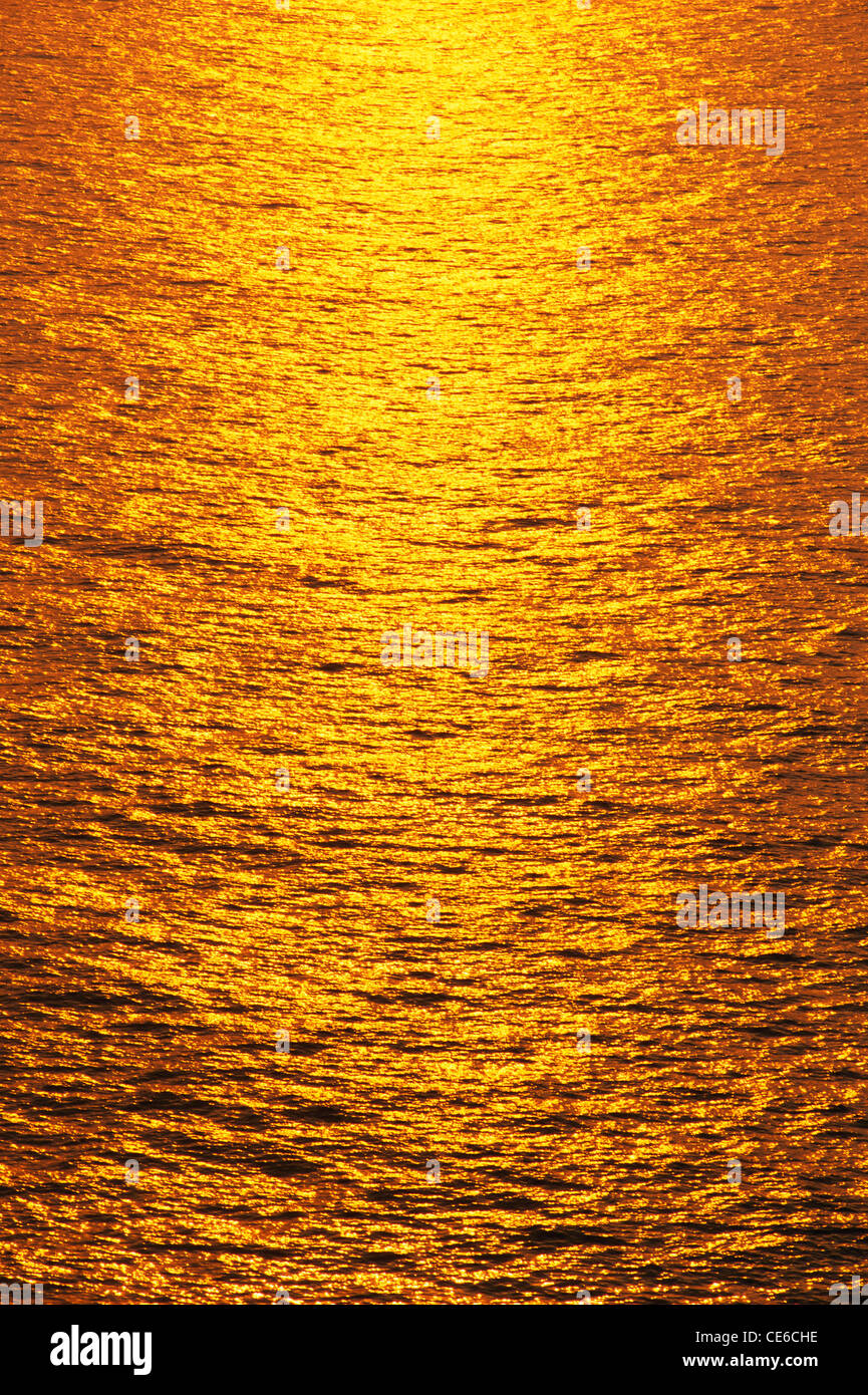 Golden sparkling sea water at sunset ; ratnagiri ; maharashtra ; india ...