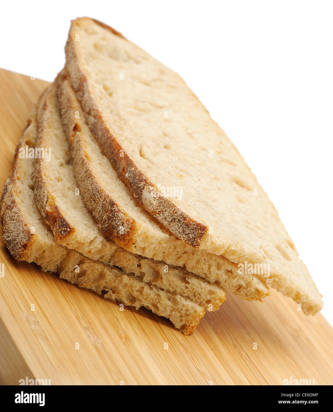 The cut bread on a chopping board. It is isolated on a white background ...