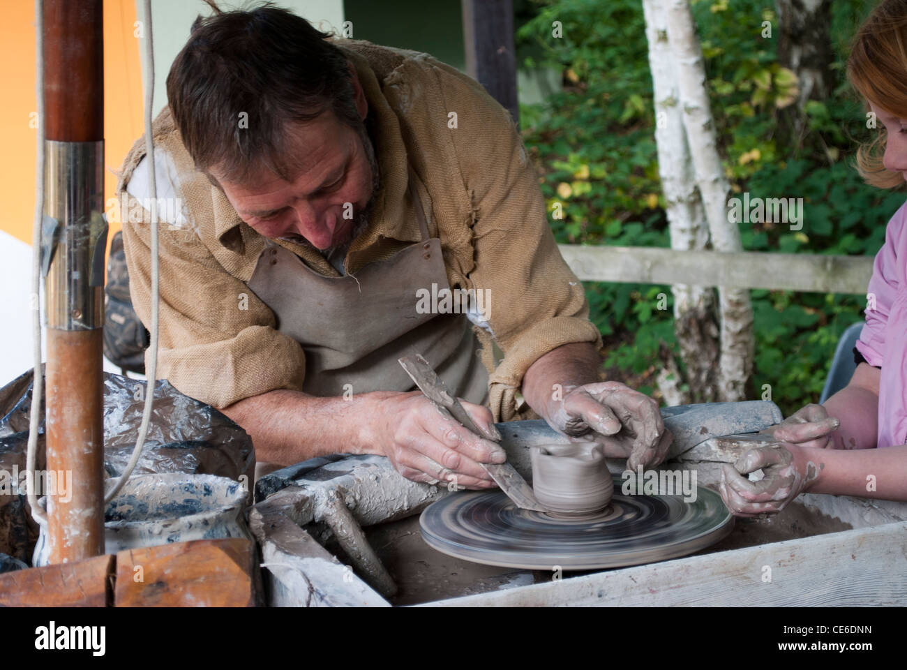 Potter using wheel at stall at medieval fair Stock Photo - Alamy