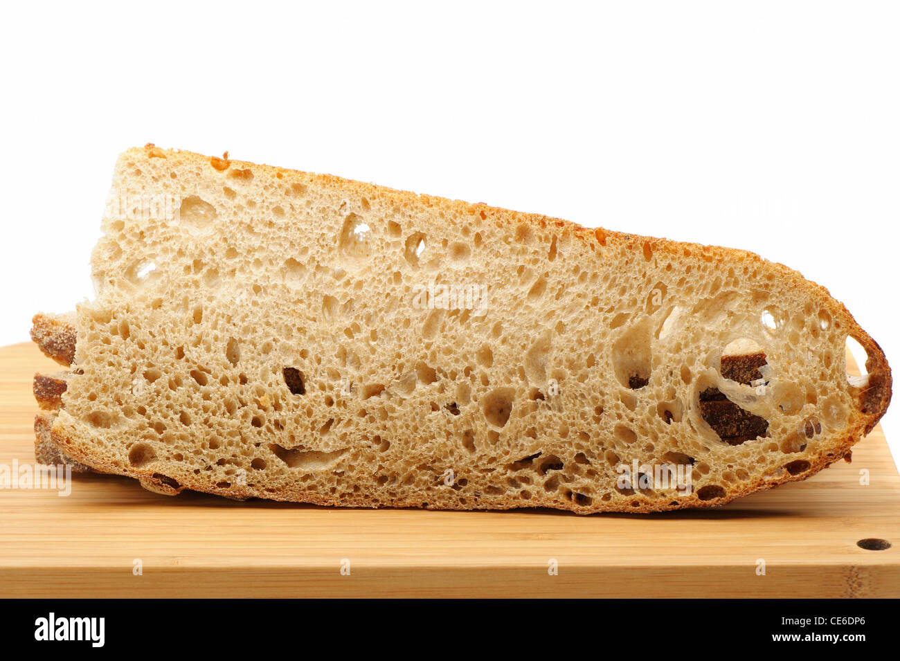 The cut bread on a chopping board. It is isolated on a white background ...