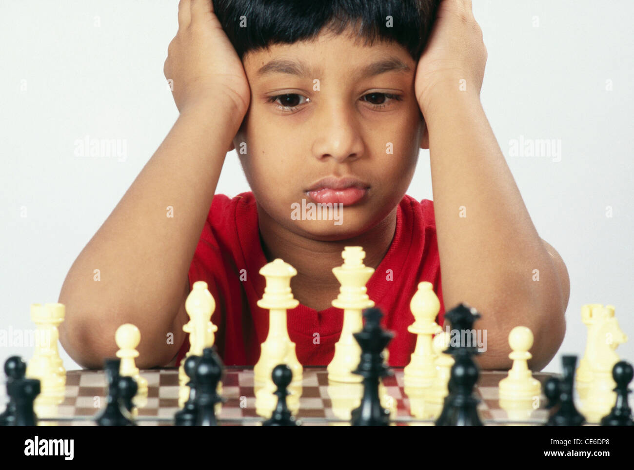 Indian small young boy child playing chess ; India ; Asia ; MR#152 ...