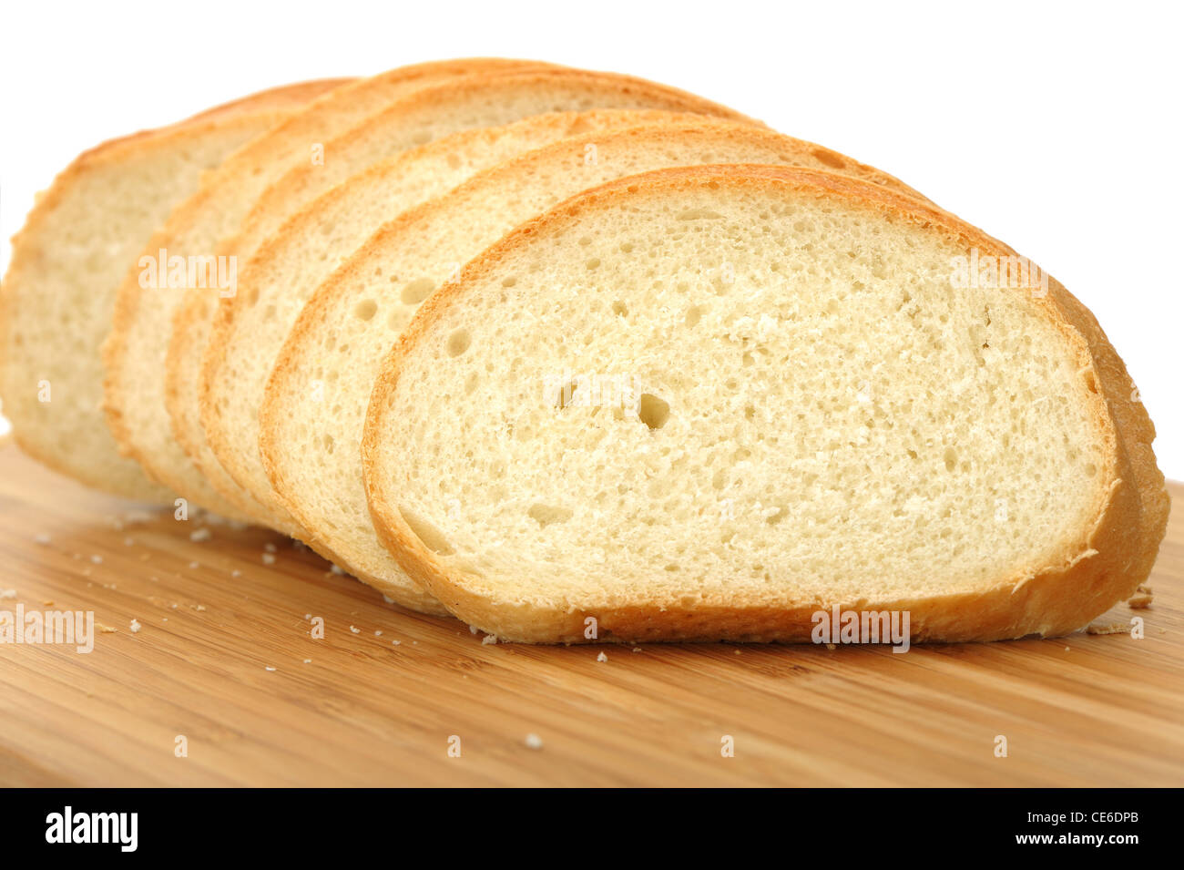 The cut bread on a chopping board. It is isolated on a white background ...