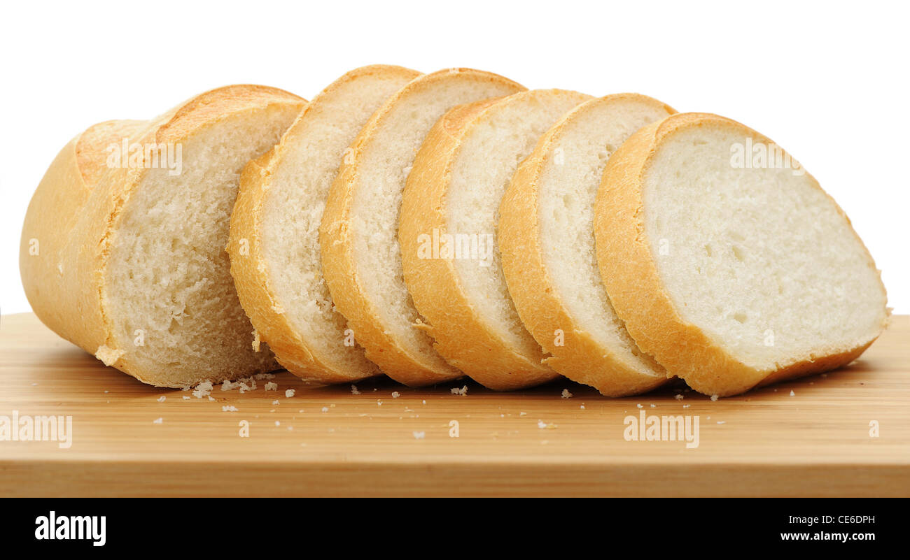The cut bread on a chopping board. It is isolated on a white background ...