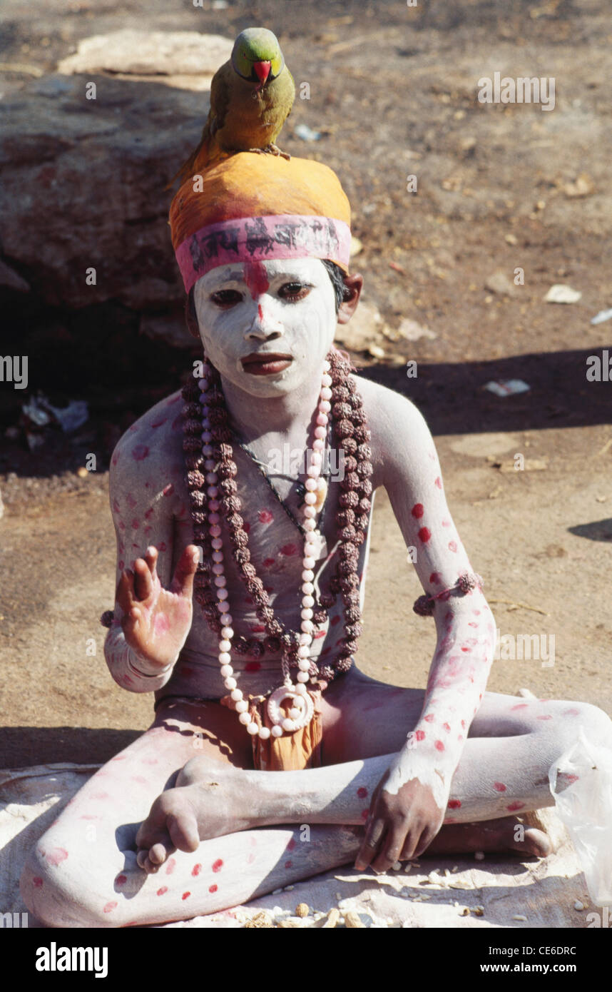 Indian child sadhu beggar ash smeared rudraksh beads parrot sitting ...