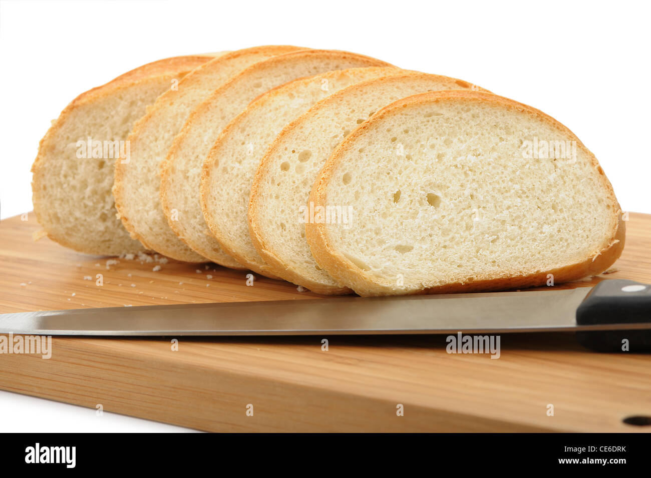 The cut bread on a chopping board with a knife. It is isolated on a ...