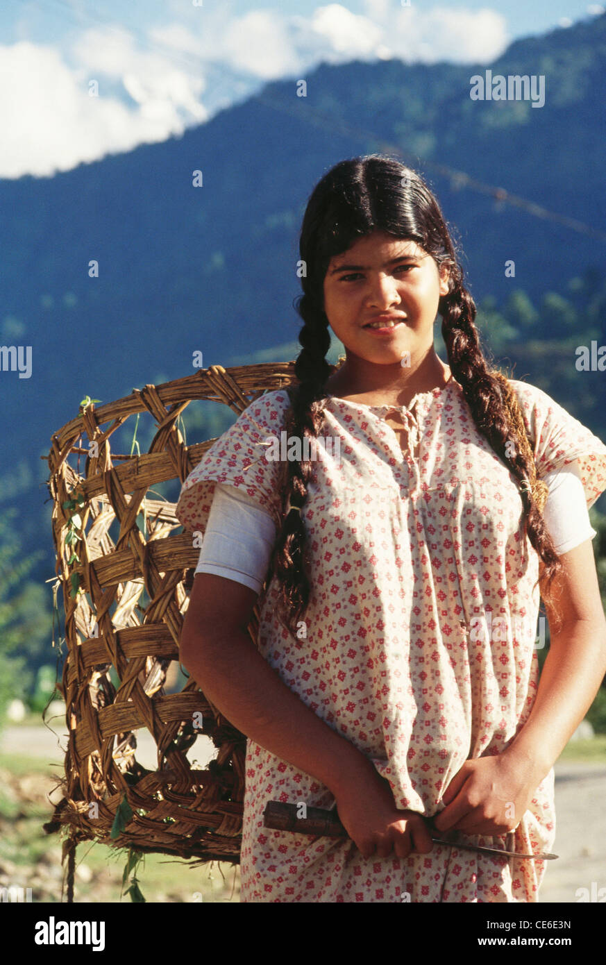 Child labour children working Girl carrying cane basket on her back ...