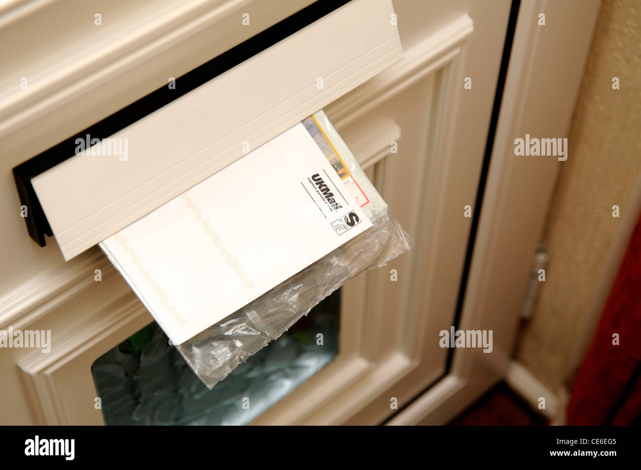 letters being pushed through a letterbox england uk Stock Photo - Alamy