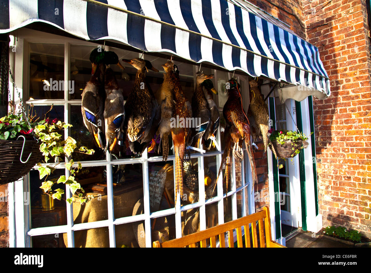 Traditional Butchers Shop with Game Hanging Outside Stock Photo - Alamy