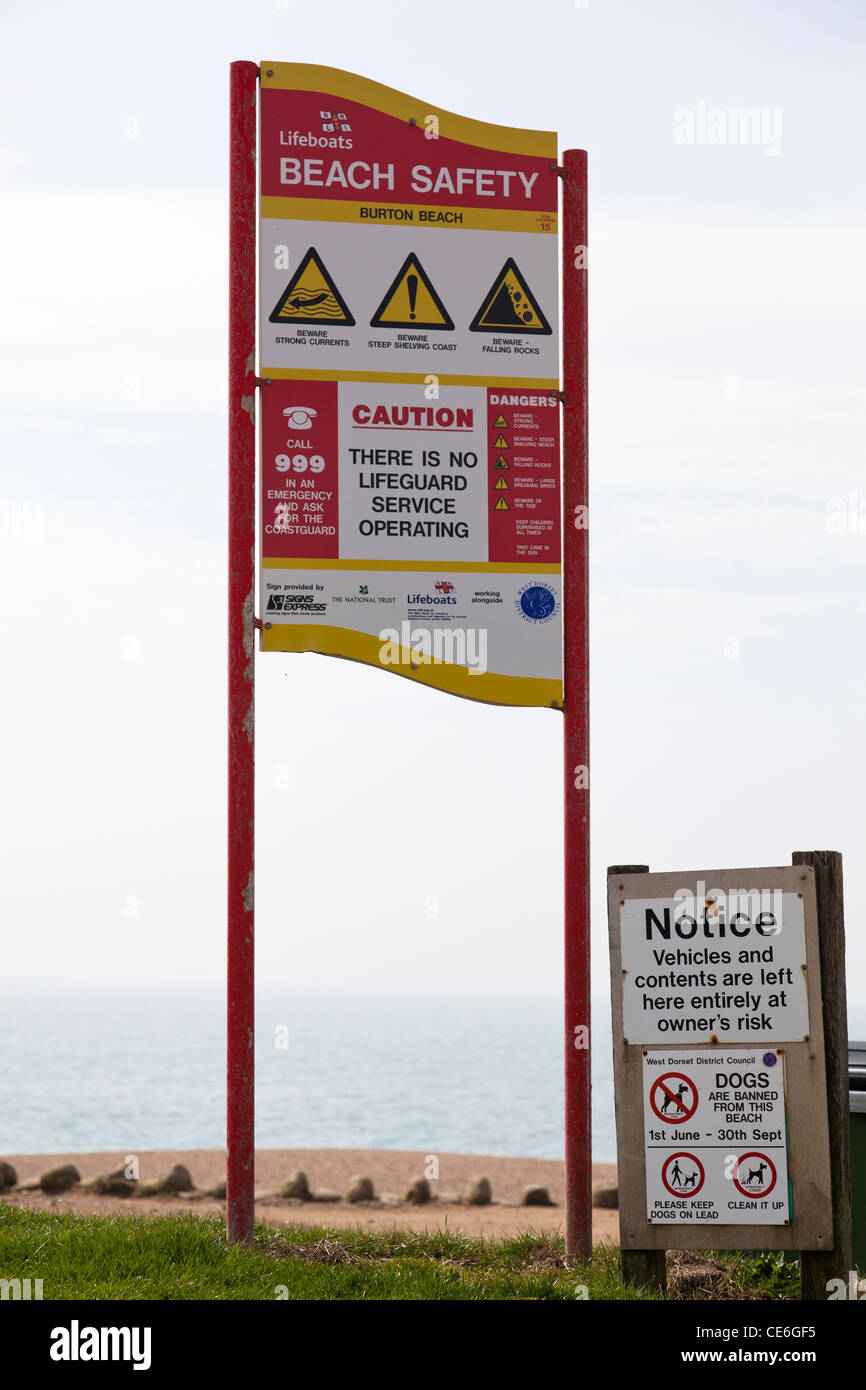 Beach safety and other warning signs next to the beach at Burton ...