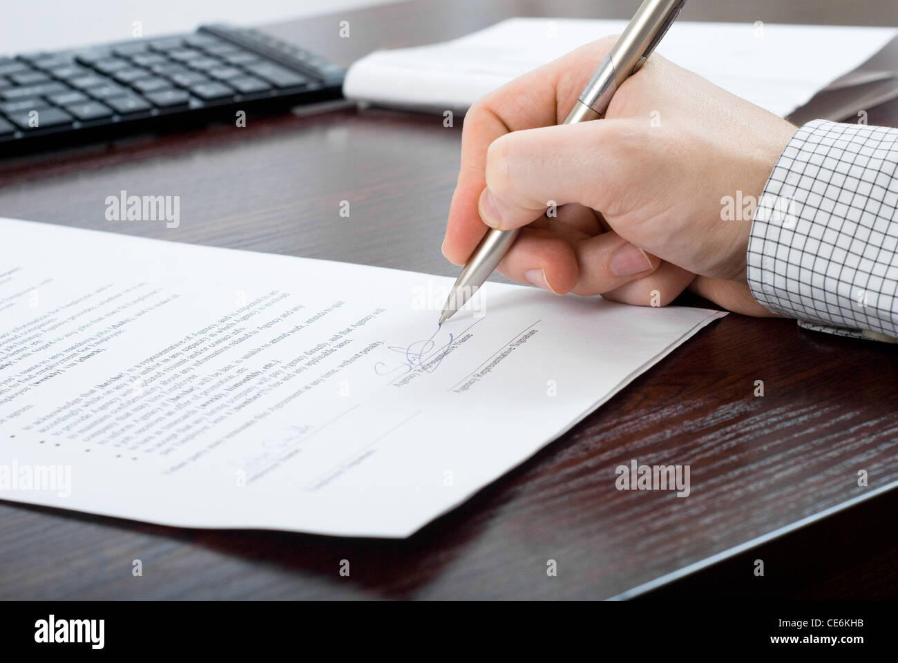 Close up shoot of signing contract by a businessmen at his desk Stock ...