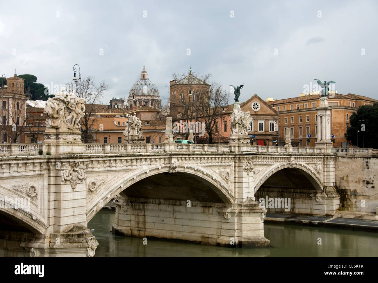 A bridge over the Tiber River, Rome, Italy, with the imposing dome of ...