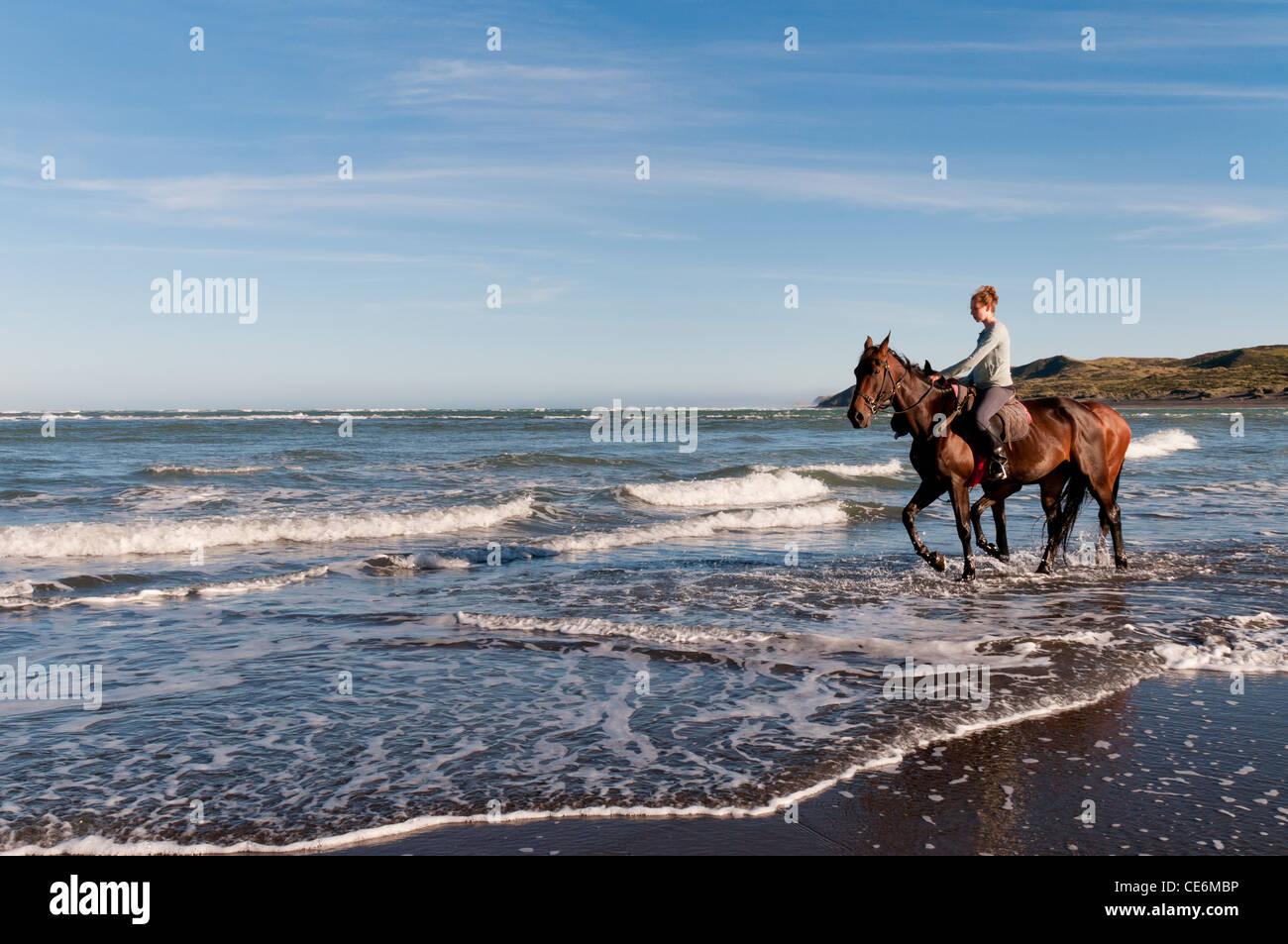Woman riding horse into sea hi-res stock photography and images - Alamy