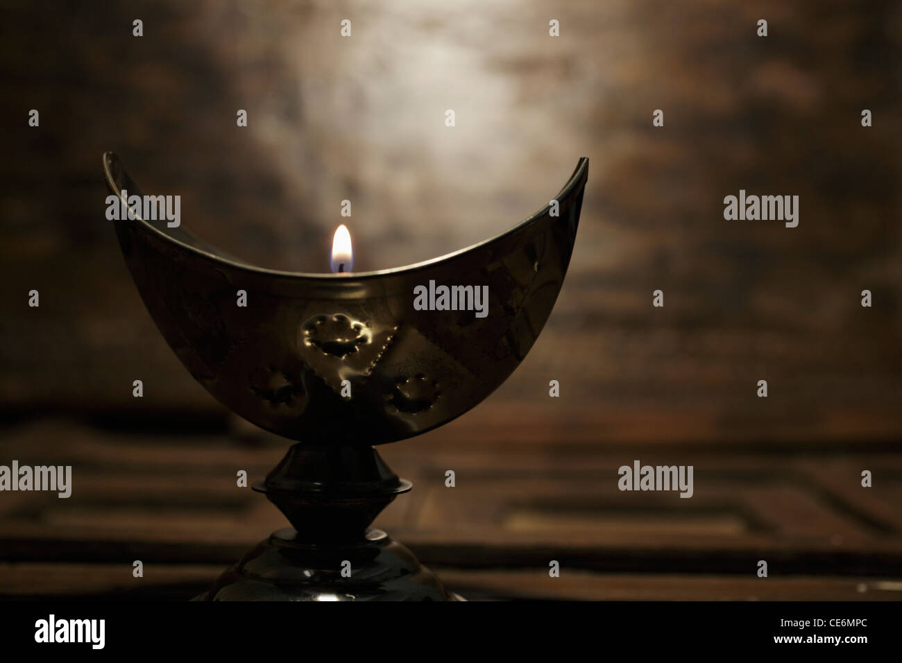 Silver cresent candle holder with lit candle Stock Photo - Alamy