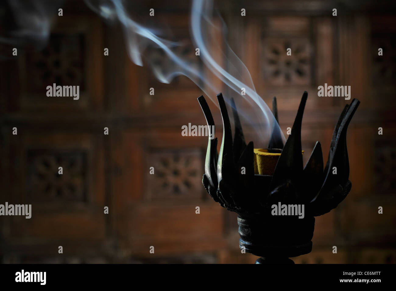 Incense burning in lotus incense burner Stock Photo - Alamy