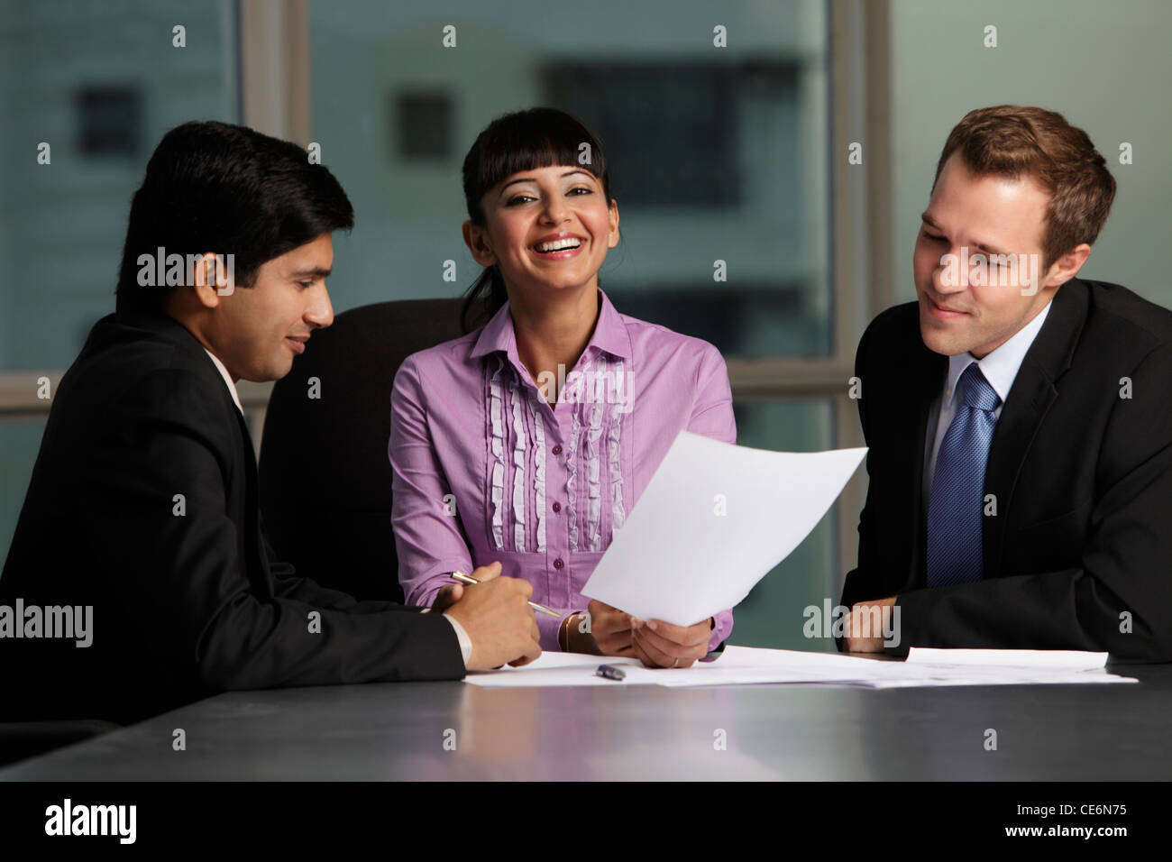 Indian woman laughing with Caucasian and Indian colleagues Stock Photo ...