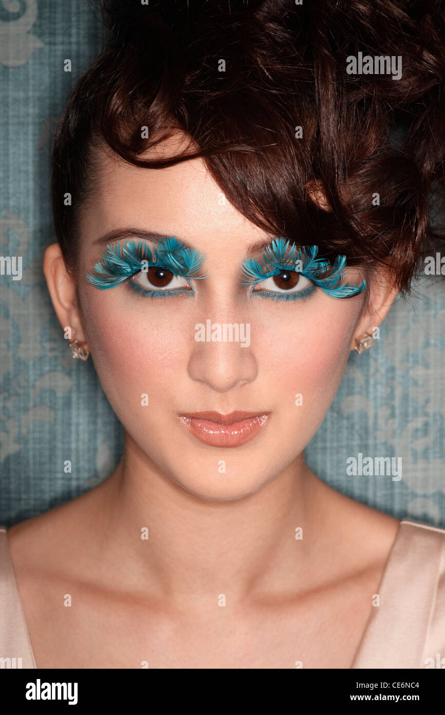 Head shot of Asian woman with false blue feather eye lashes Stock Photo ...