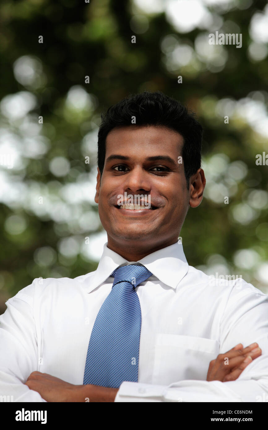 Indian man looking at camera and smiling Stock Photo - Alamy
