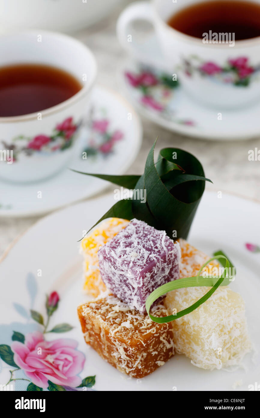 Traditional Peranakan coconut sweets with tea Stock Photo - Alamy