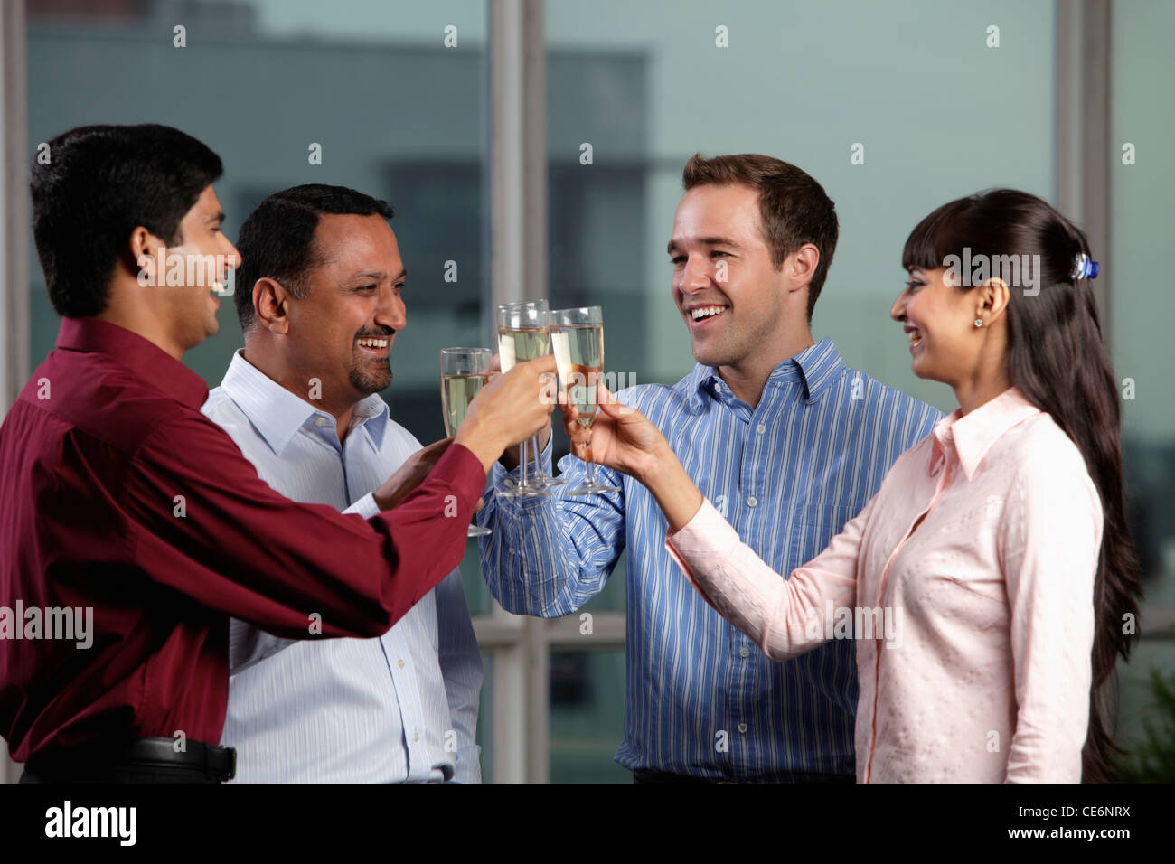 Mixed raced group toasting eachother Stock Photo - Alamy