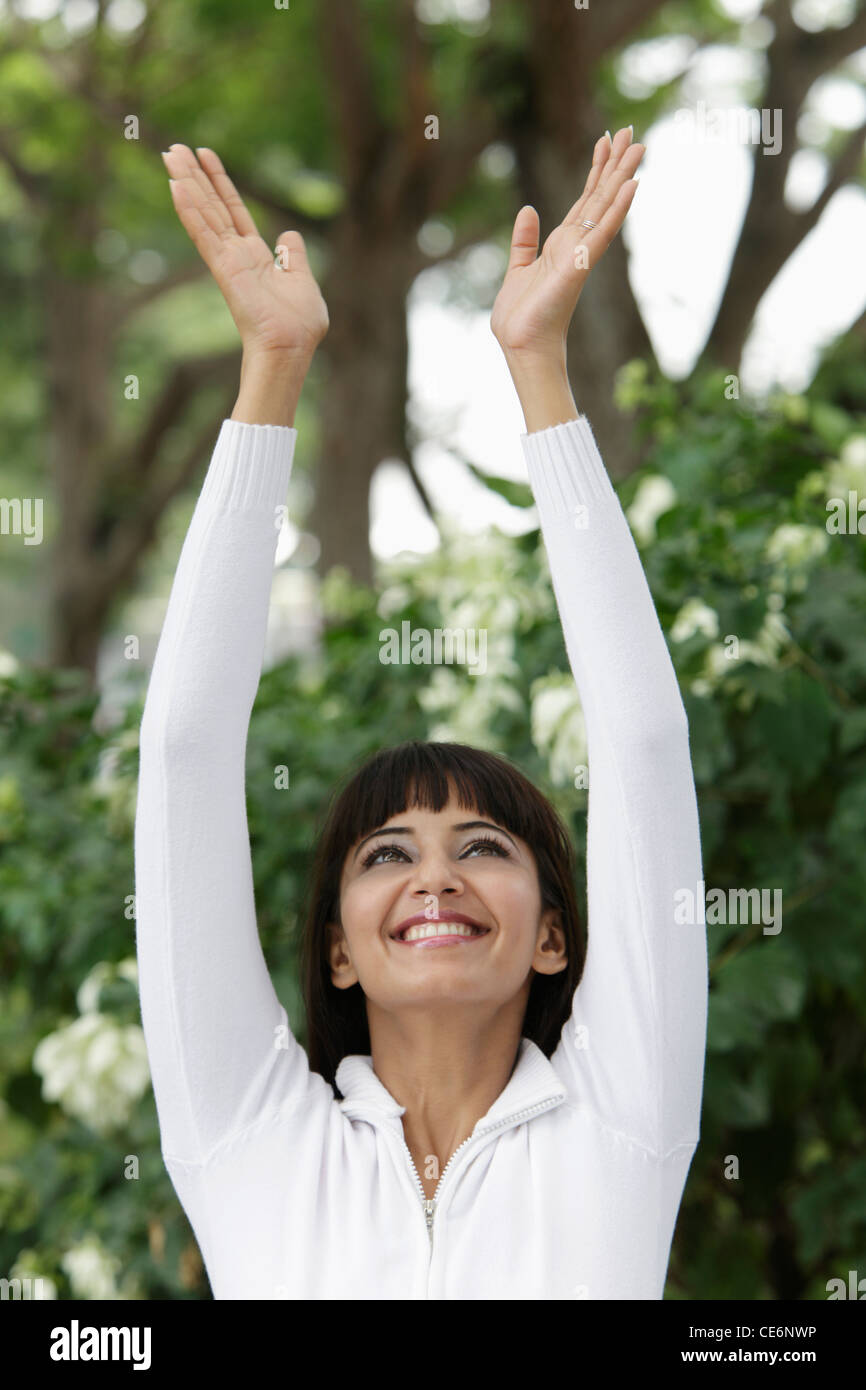 Young woman stretching arms overhead hi-res stock photography and ...