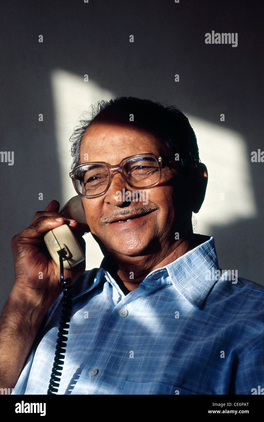 Old man talking on telephone MR#323 Stock Photo - Alamy