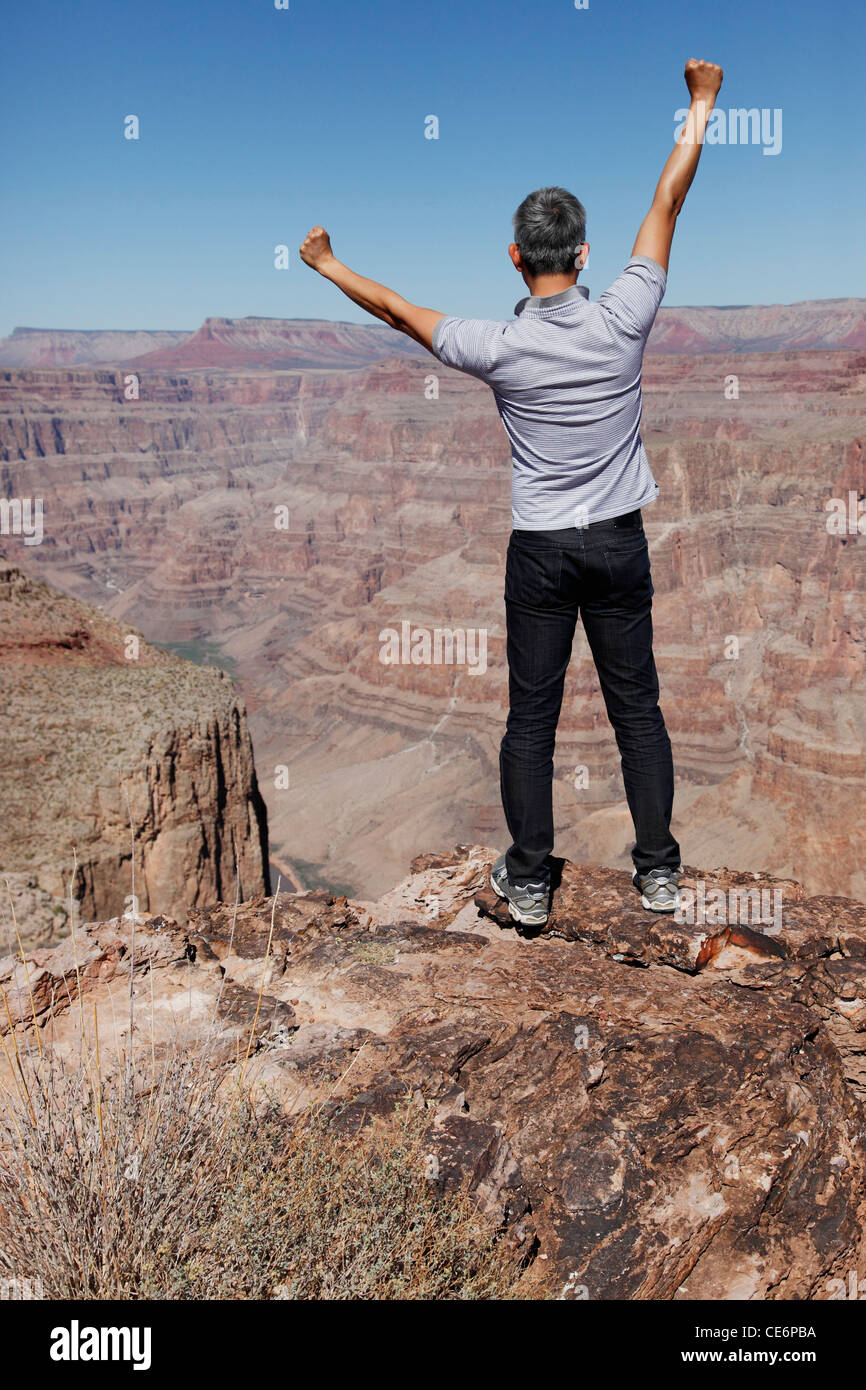 back view of man standing with arms outstretched Stock Photo - Alamy