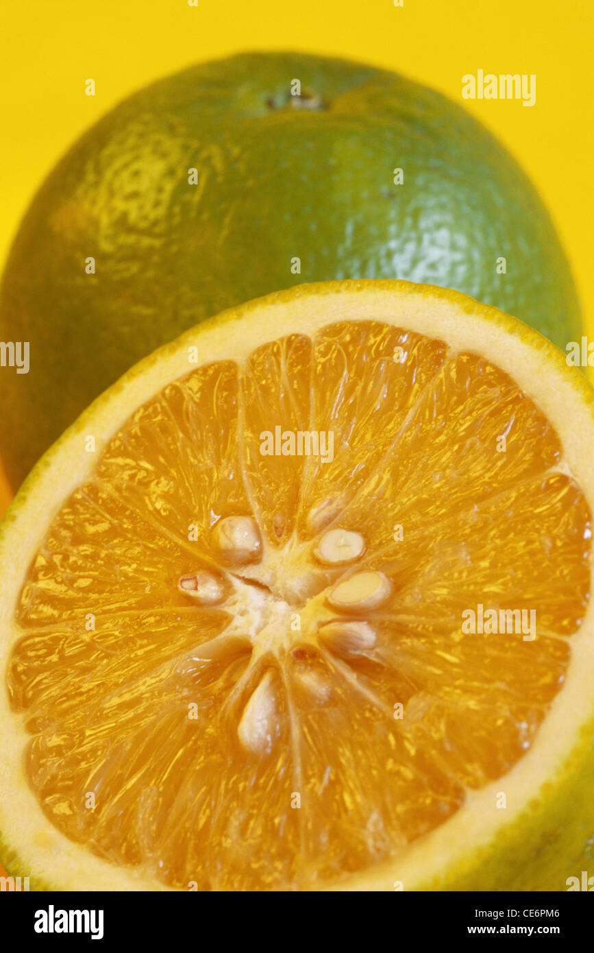 Sweet lime fruit one full and half on yellow background Stock Photo - Alamy