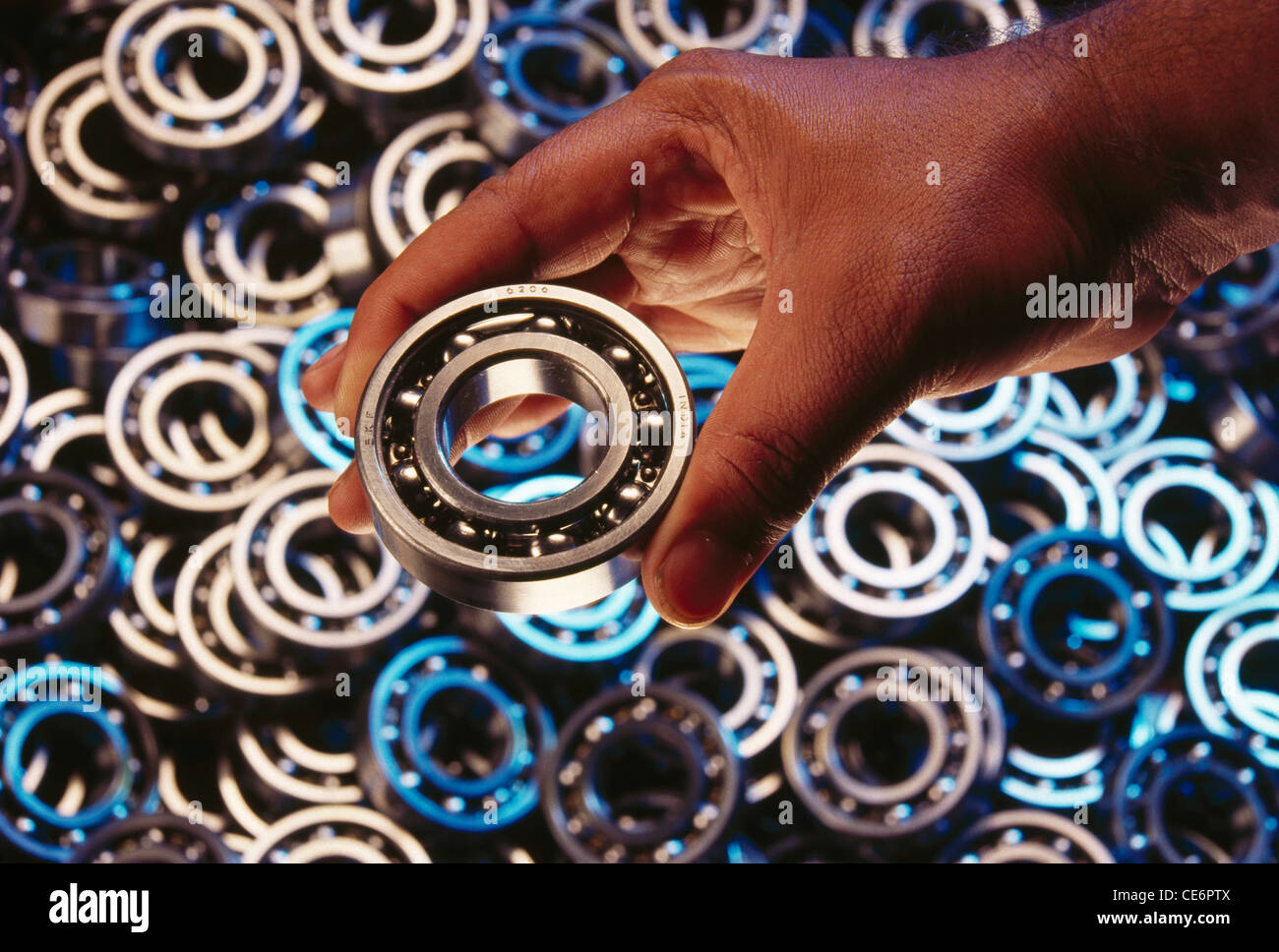 Man showing roller bearing ; rolling element bearings ; rolling bearing ...