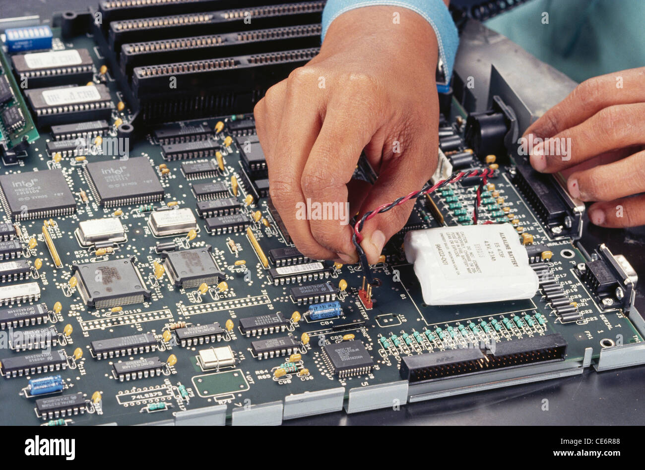 Indian man working making operating electronic integrated circuit board ...