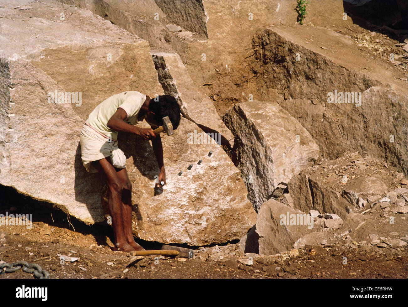 SNA 85793 : man making holes to put dynamite marble stone mining quarry ...