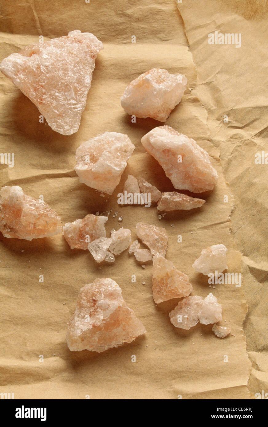 Rock salt on brown paper background Stock Photo - Alamy