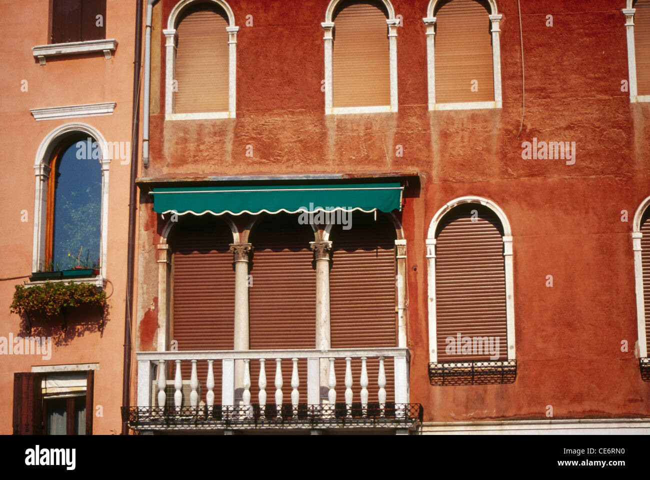 windows and balcony with canopy awning of old building ; venice ...
