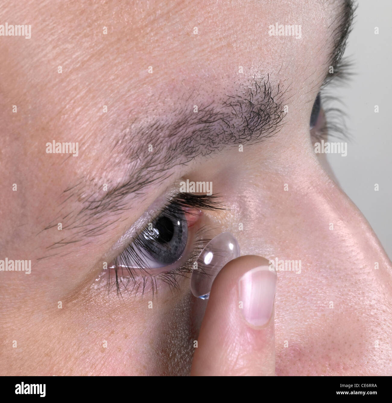 detail of a eye while placing a contact lens Stock Photo - Alamy
