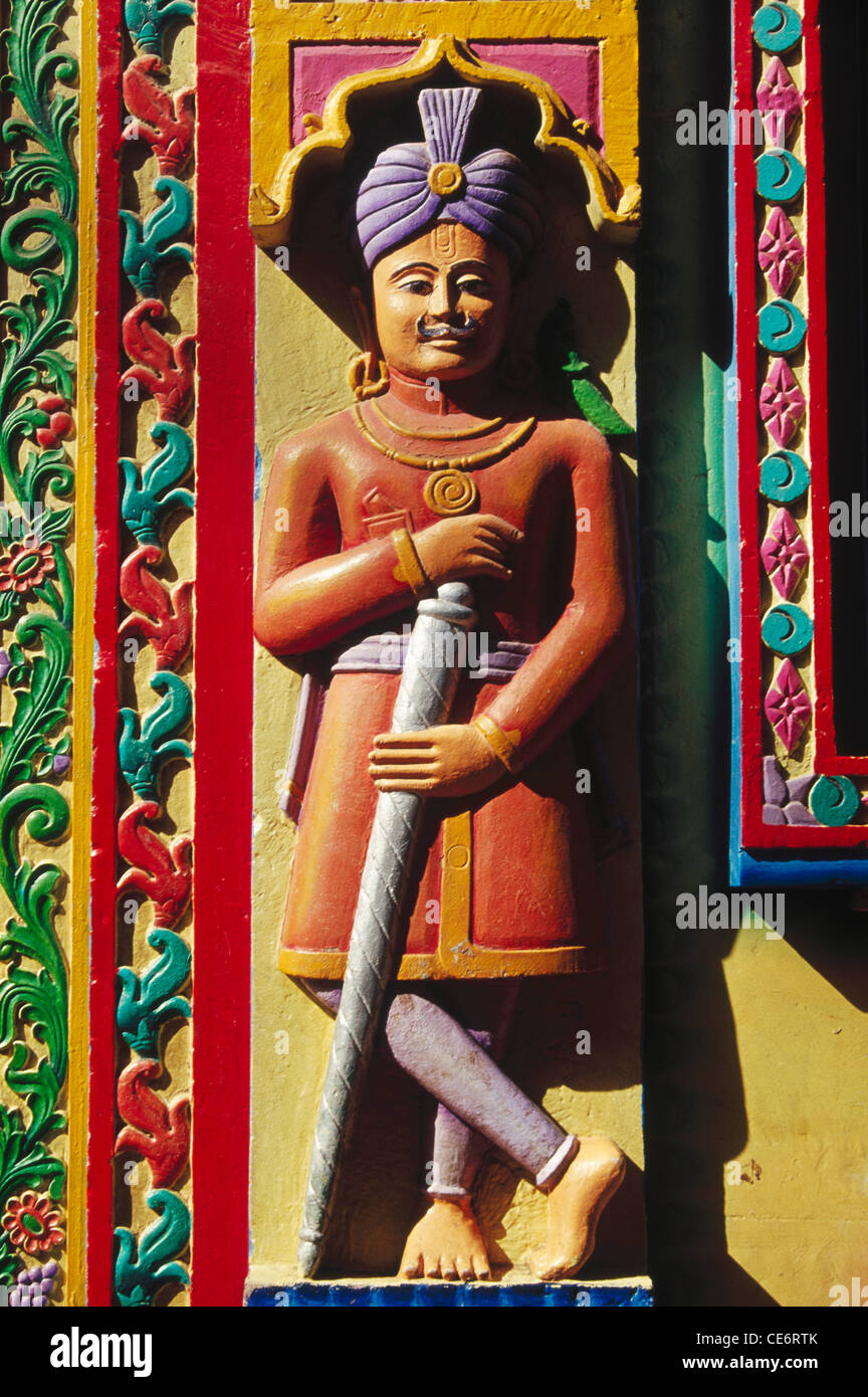 painted statue of dwarpal door keeper at entrance of temple ; bhuj ...