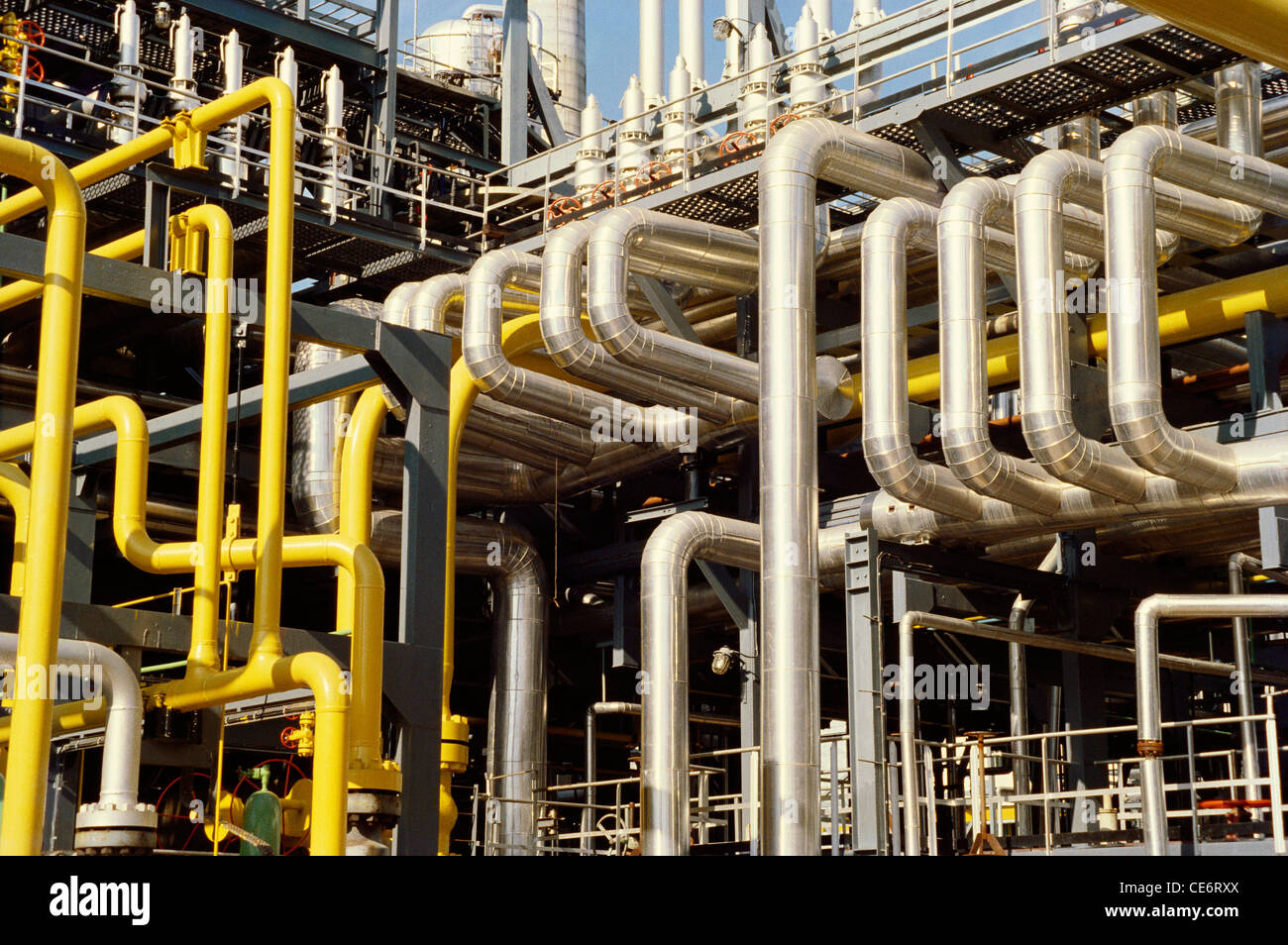 many pipes painted golden yellow silver white chemical industry factory ...