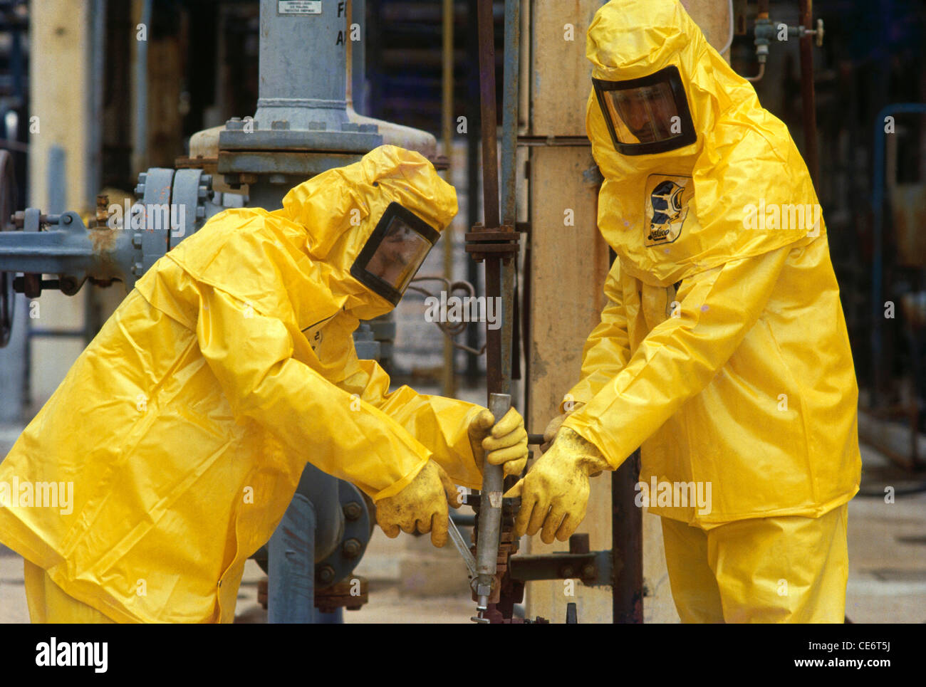 Two men wearing protective clothing working in oil rig plant india ...