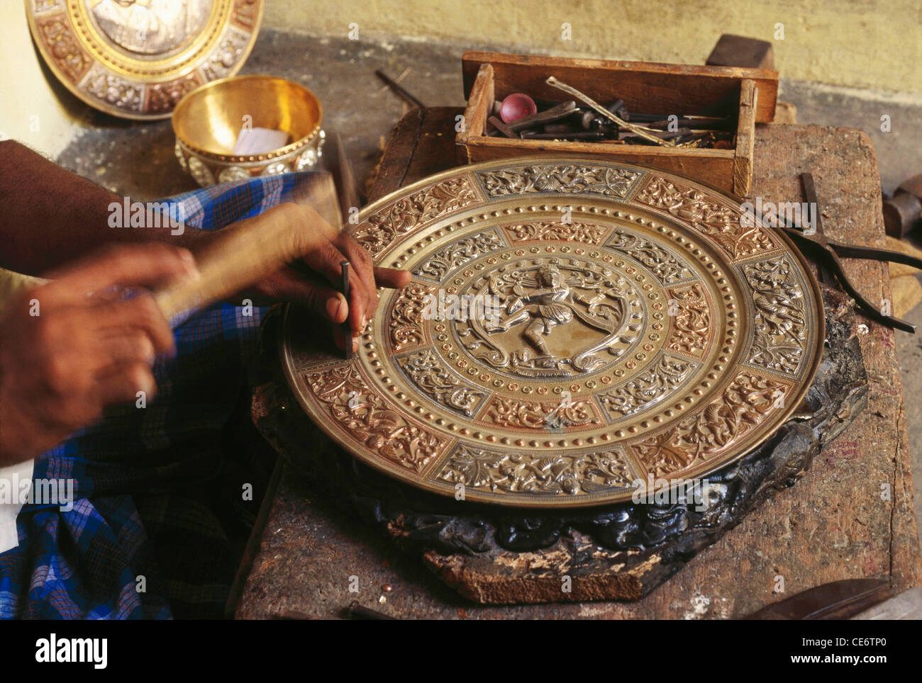 man carving lord shiva on round metal plate thanjavur art tanjore tamil ...
